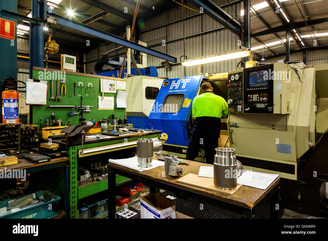 workmen finishing and polishing metal and plastic components ahead of ...