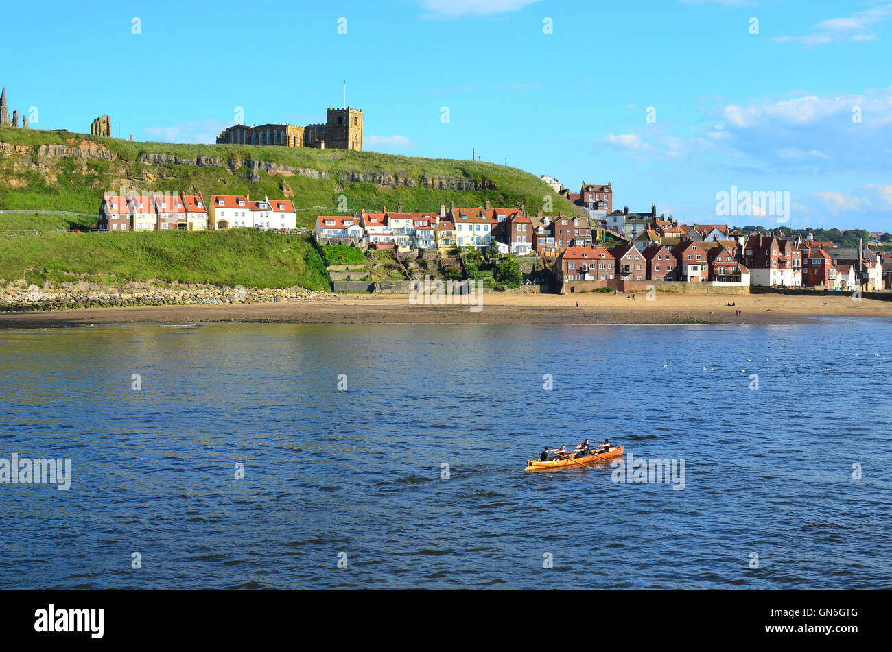 Rowing boat entering Whitby harbour North Yorkshire England UK Stock ...