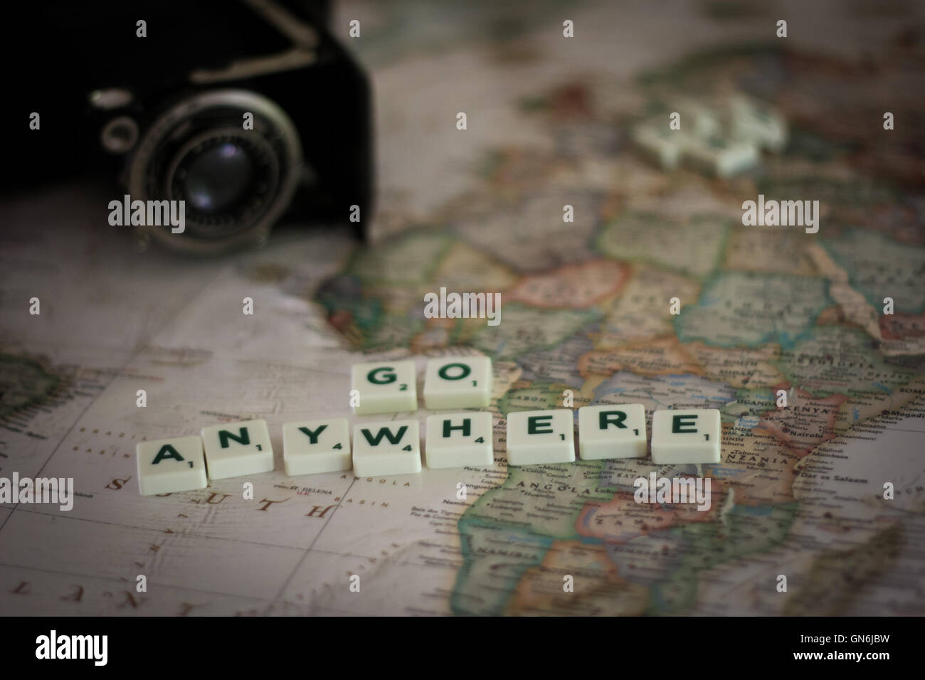 World map with words and quote using lettered tiles Stock Photo - Alamy