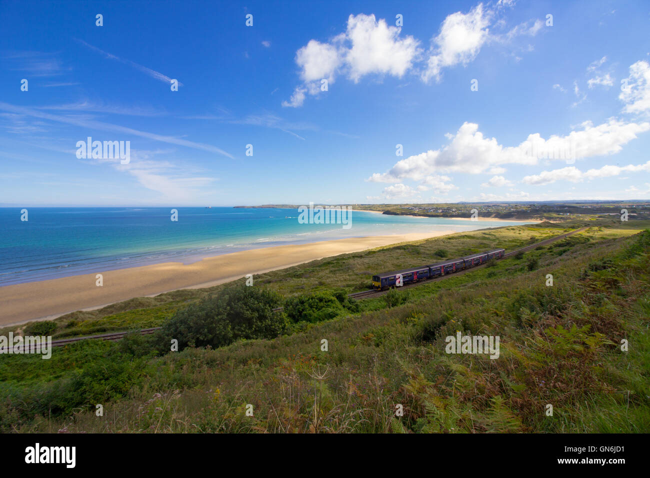 A train runs on the picturesque St Ives Bay Railway Line passing ...