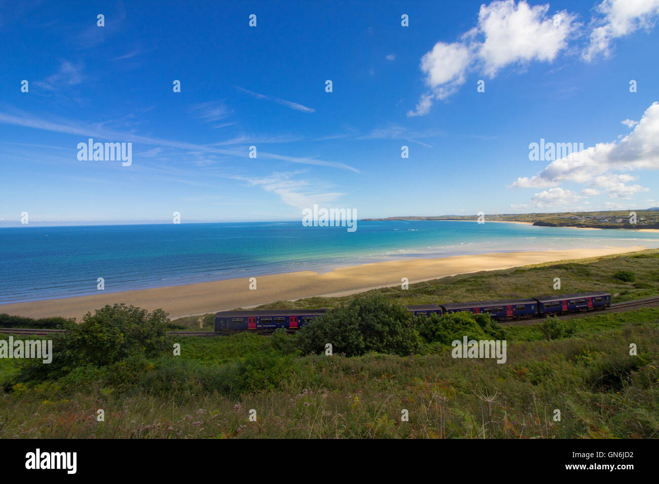 A train runs on the picturesque St Ives Bay Railway Line passing ...