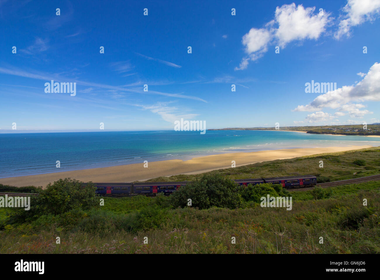 A train runs on the picturesque St Ives Bay Railway Line passing ...