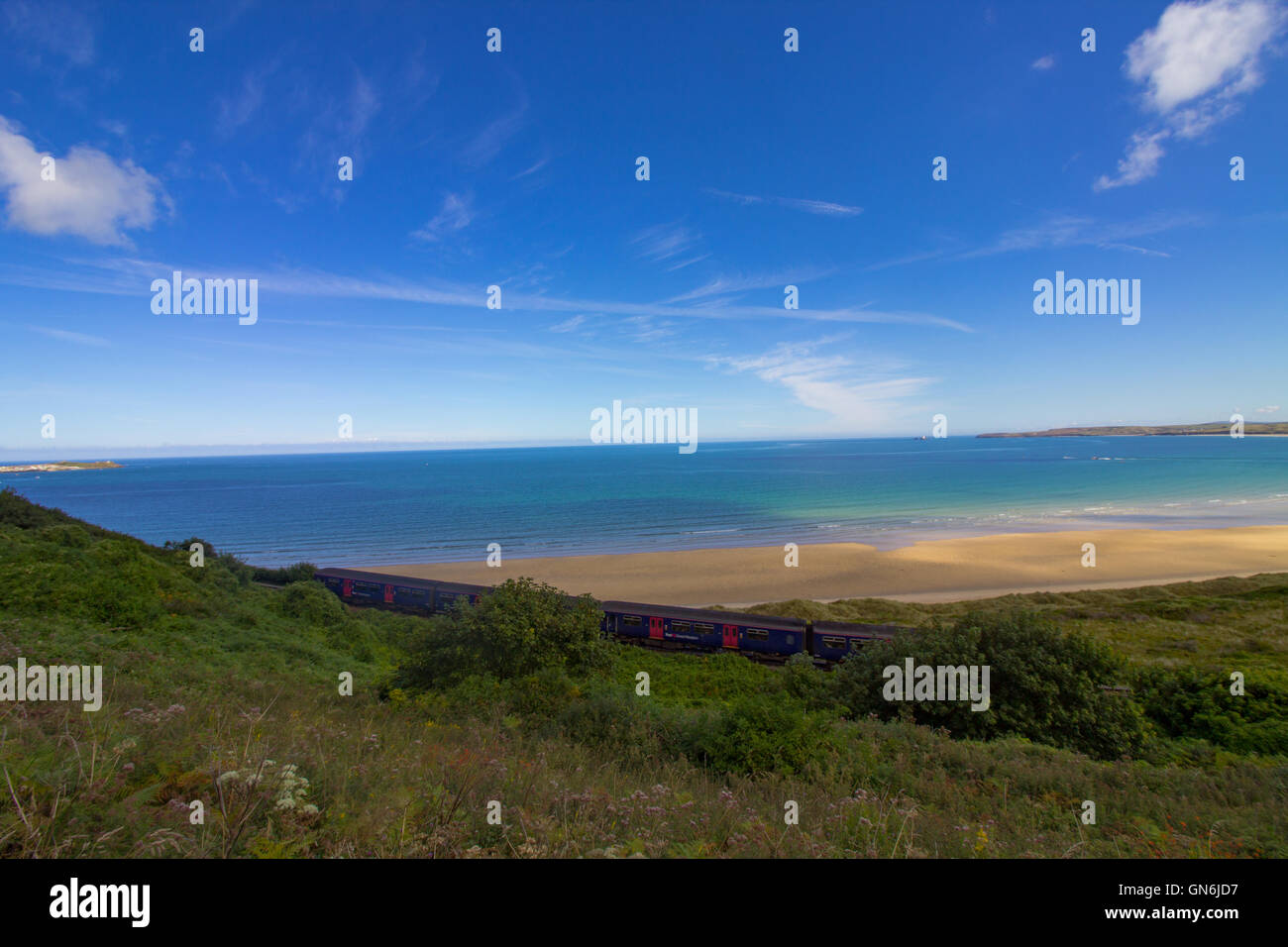 A train runs on the picturesque St Ives Bay Railway Line passing ...