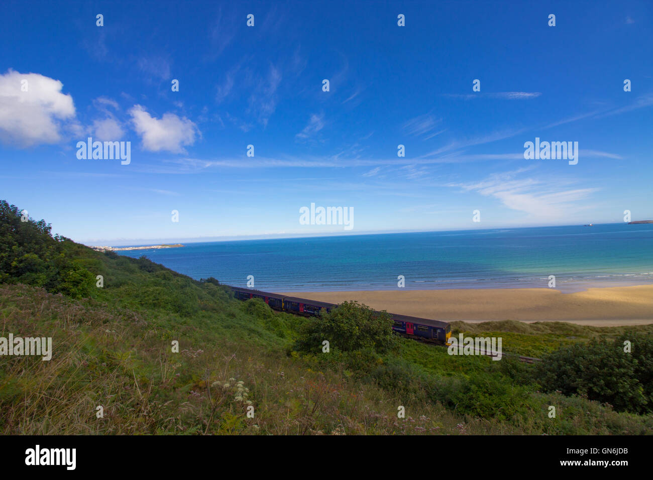 A train runs on the picturesque St Ives Bay Railway Line passing ...