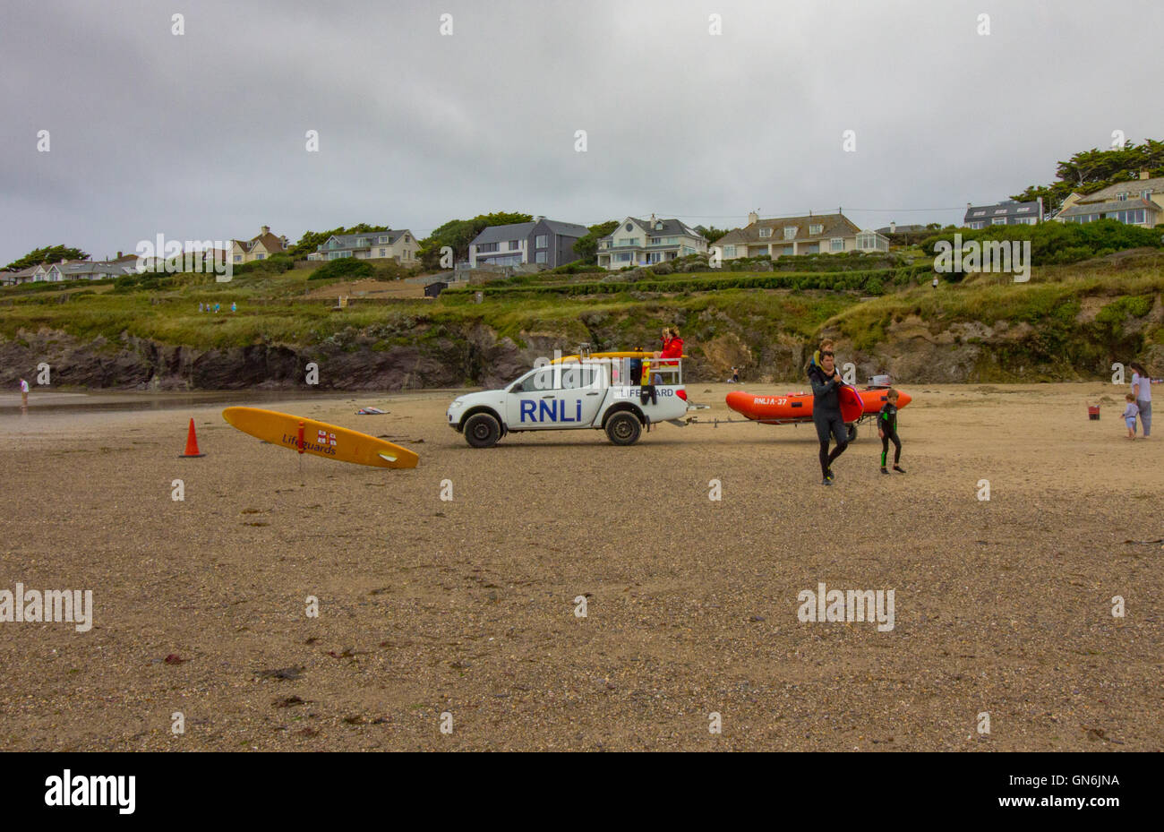 RNLI Lifeguards keep watch as people learn to surf on Polzeath Beach ...