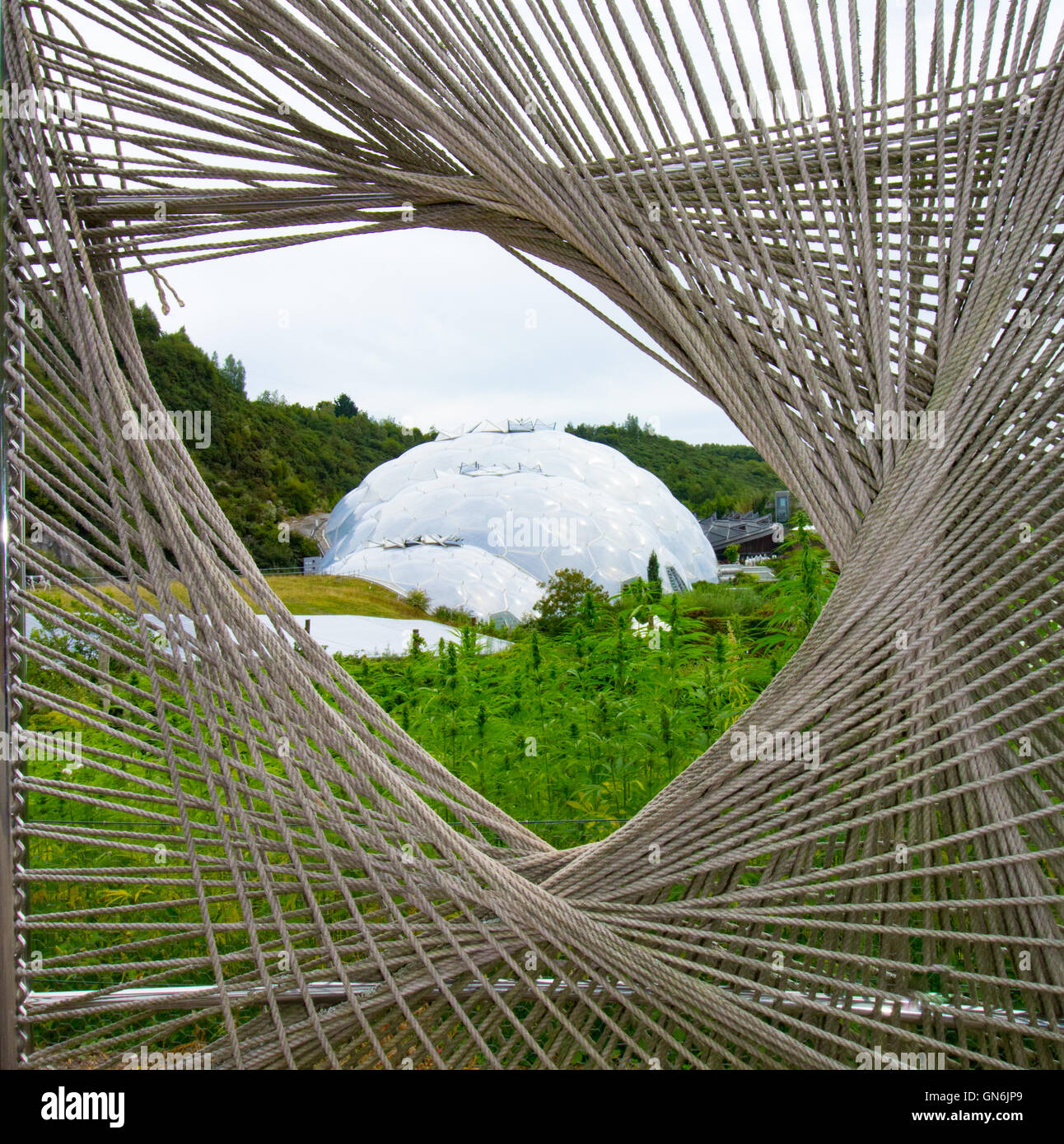 Biome at the Eden Project pictured through a weaved net fence Stock ...