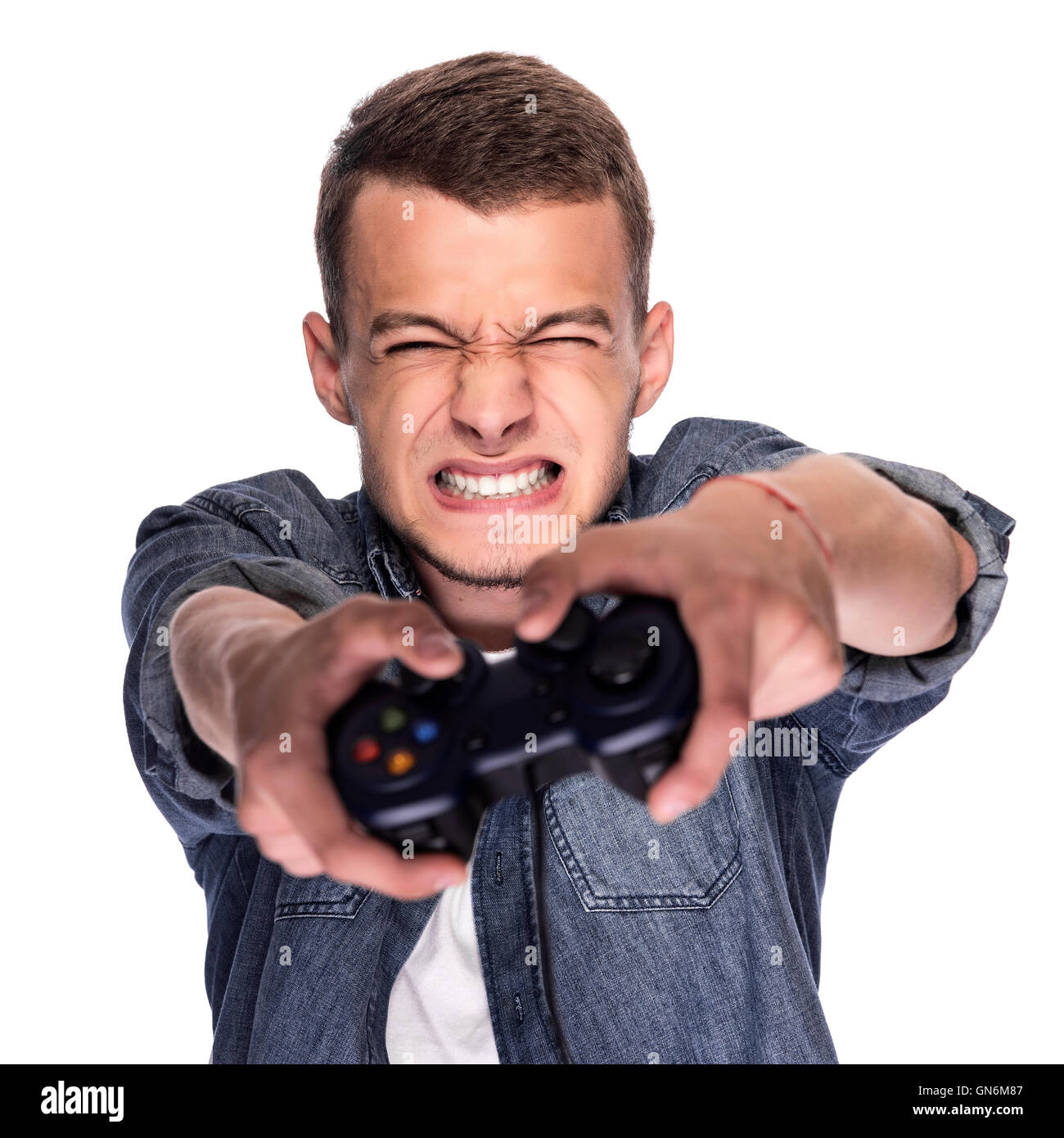Young man playing on console or computer using a gamepad Stock Photo ...