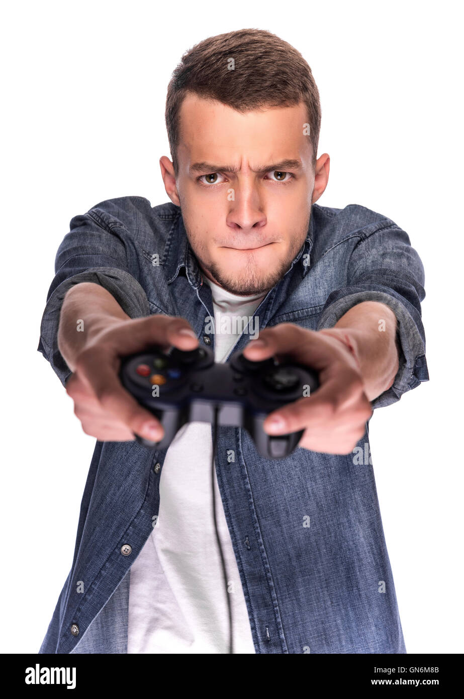 Young man playing on console or computer using a gamepad Stock Photo ...