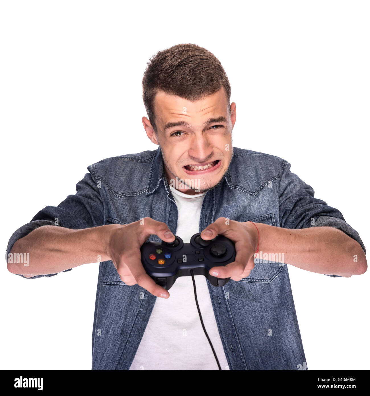 Young man playing on console or computer using a gamepad Stock Photo ...