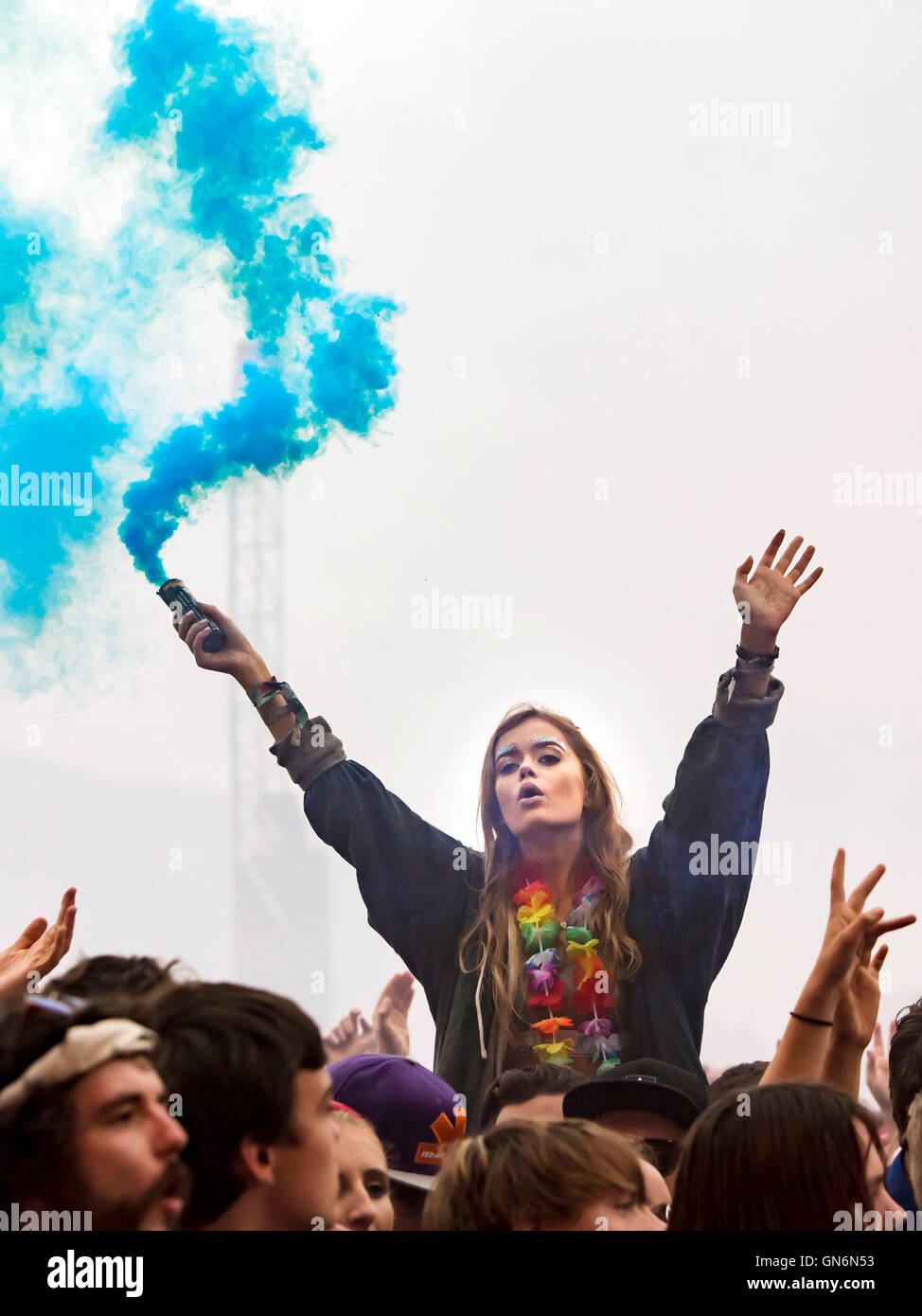 Coloured smoke flares are set off by festival-goers during a ...