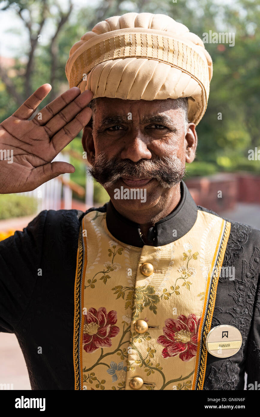 A hotel doorman wearing his full uniform at a 5-star hotel, greets all ...