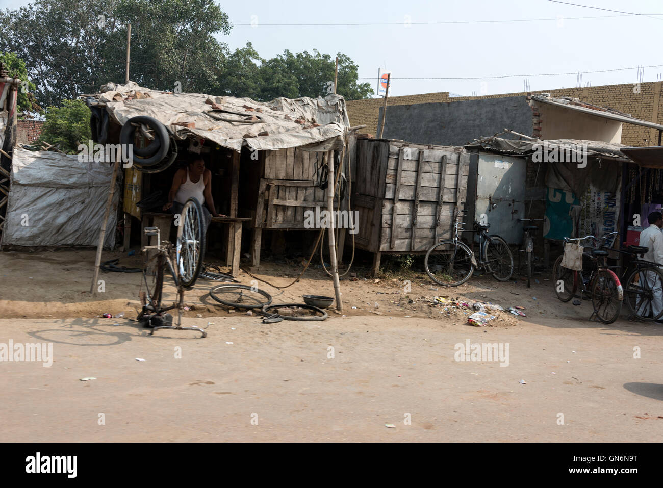 Makeshift shops in a slum area on the main street, Agra, Uttar Pradesh ...