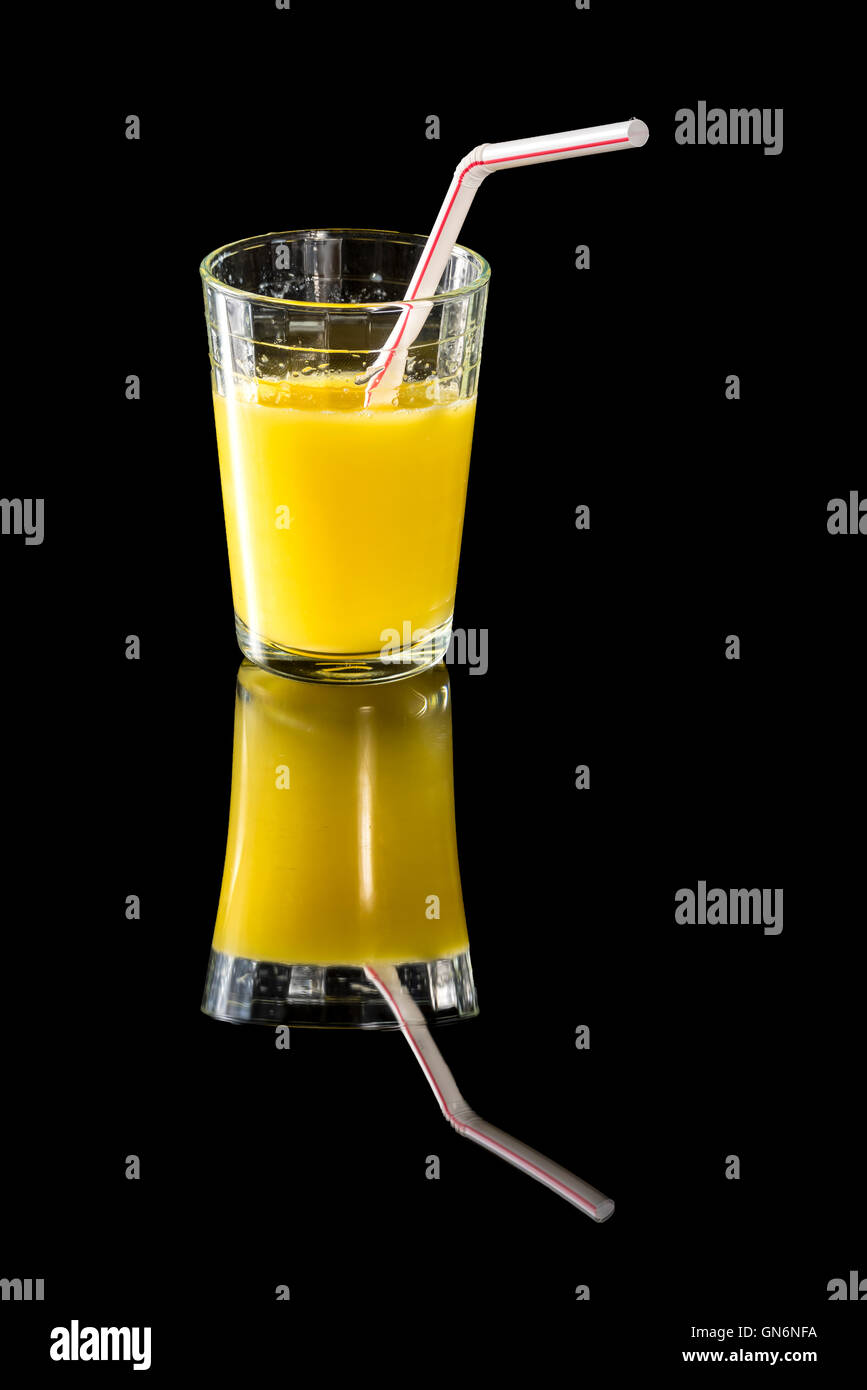 Glass of fruit juice with a straw in it Stock Photo - Alamy