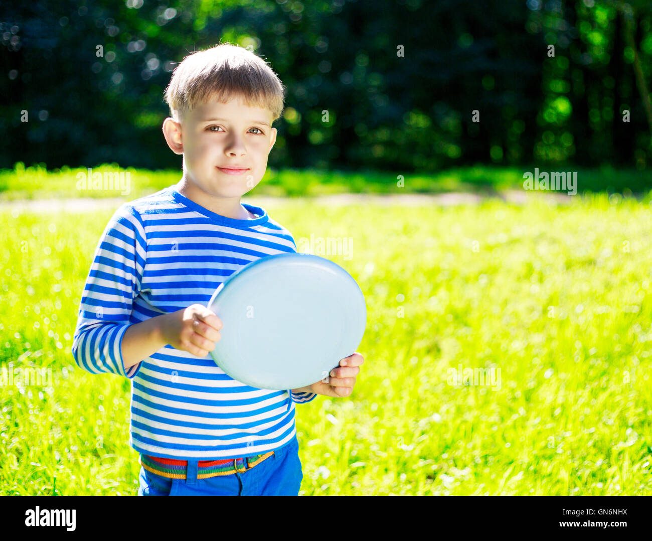 happy boy playing Frisbee outdoor on a summer day Stock Photo - Alamy