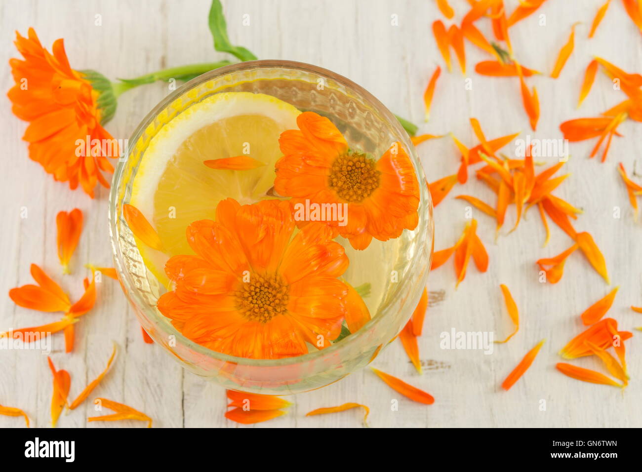 marigold flower herbal tea with lemon slices in a glass Stock Photo - Alamy