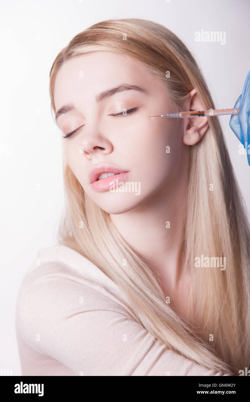 Beautiful spa woman receives procedures for injections of botox for the ...