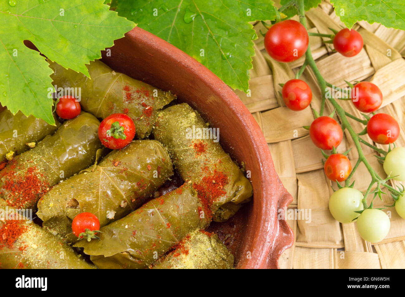 Sarma rolls in a traditional plate with cherry tomato Stock Photo - Alamy
