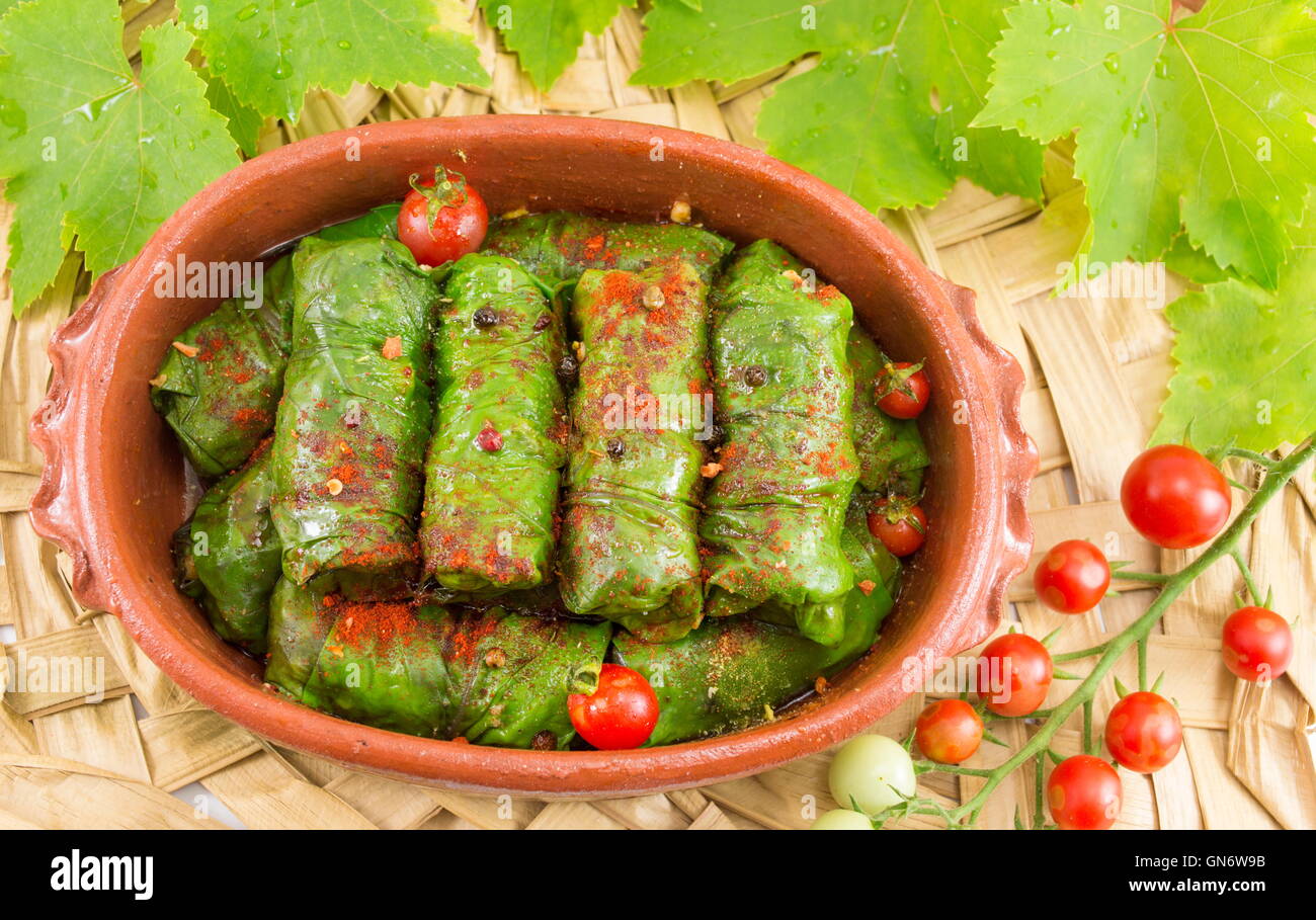Sarma rolls in a traditional plate with cherry tomato Stock Photo - Alamy