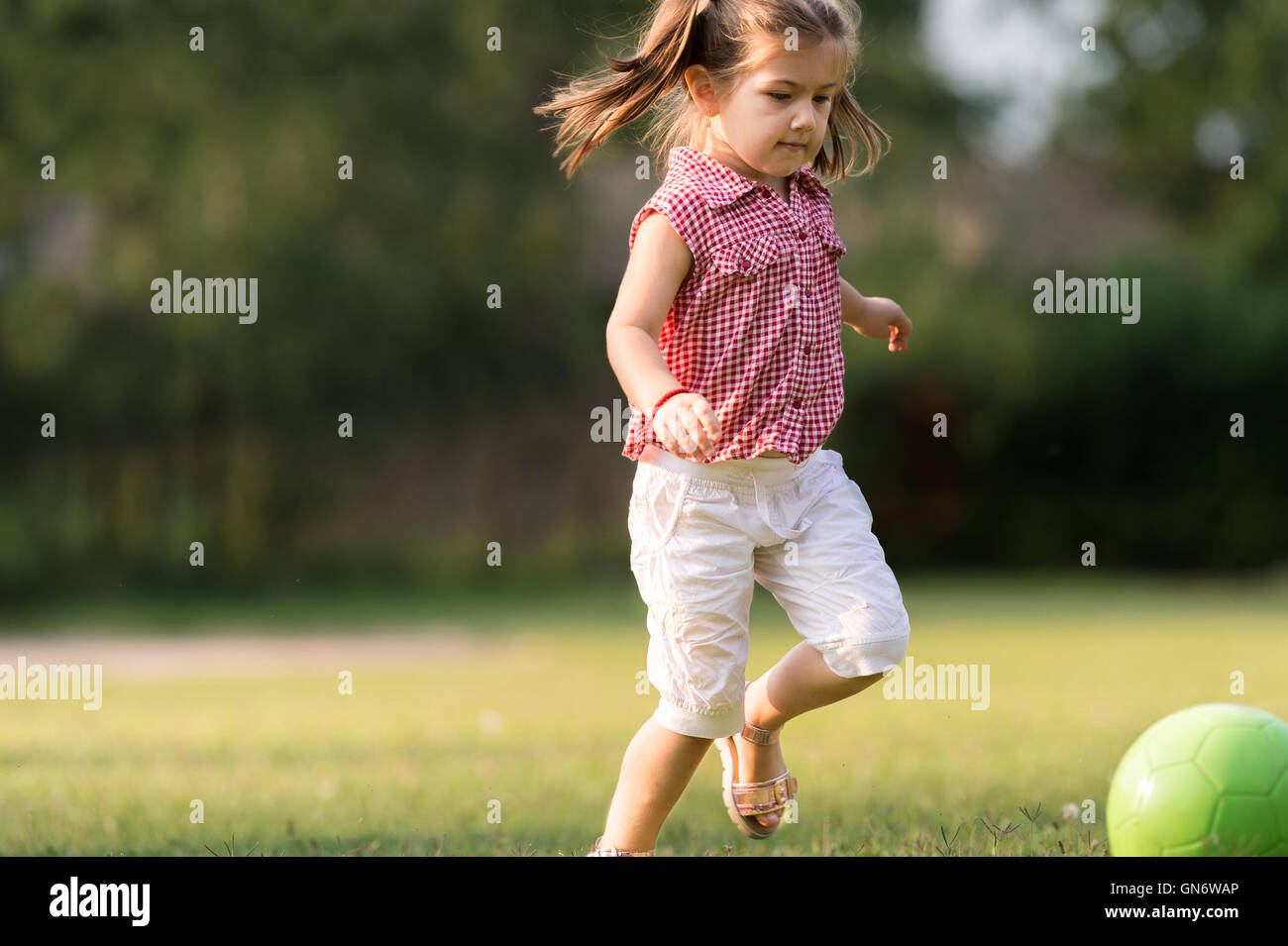 Little girl Shooting at Goal Stock Photo - Alamy