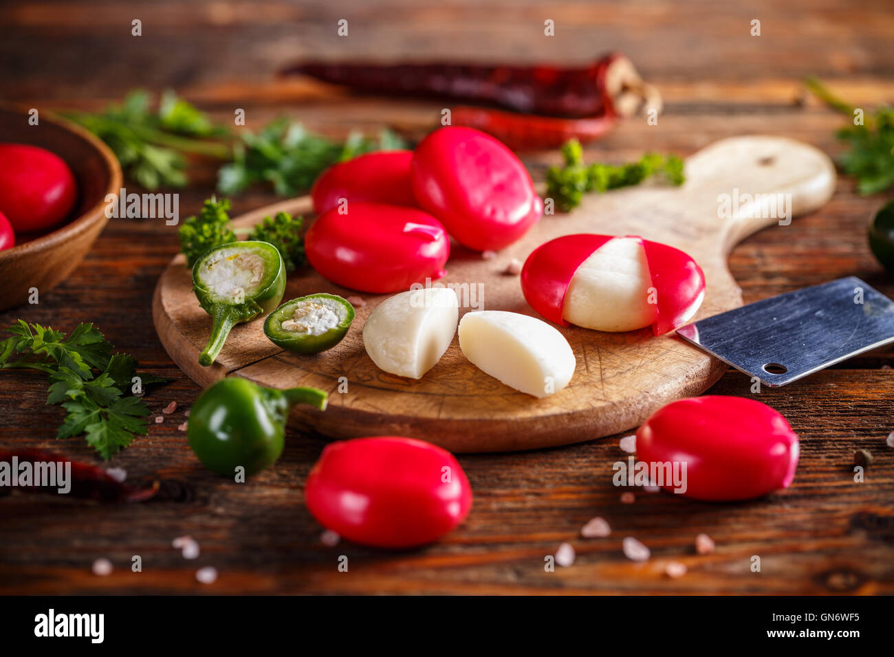 Mini soft cheese covered with red wax Stock Photo - Alamy