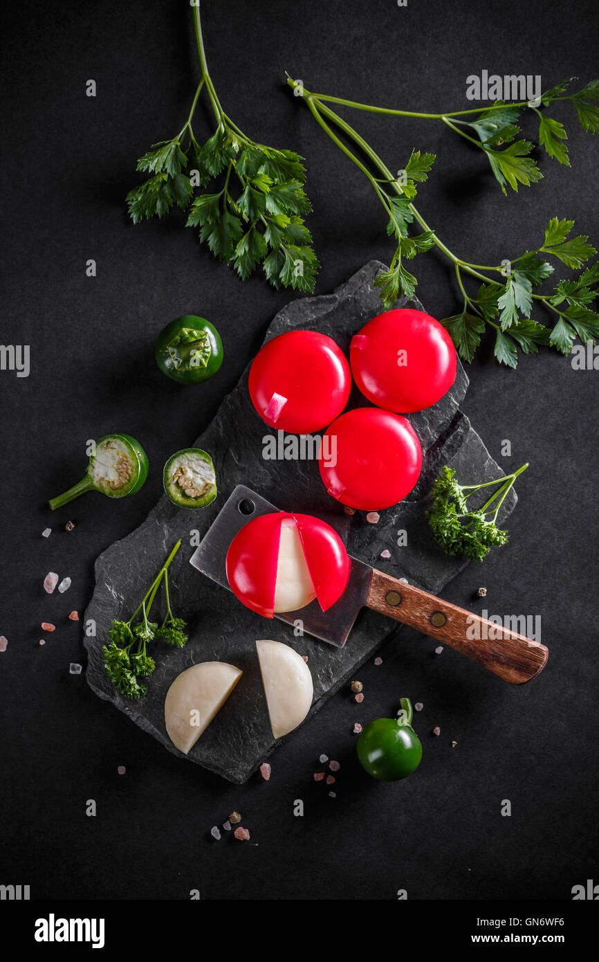 Top view of mini baby cheese balls in red wax Stock Photo - Alamy