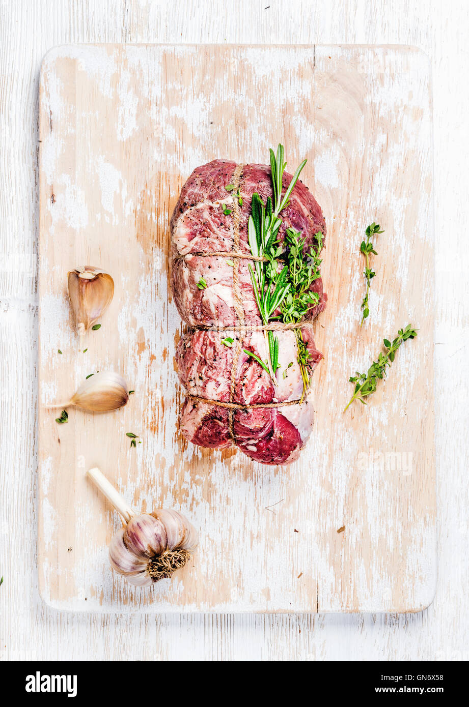 Raw roastbeef meat cut with rosemary, thyme and garlic, vertical Stock ...