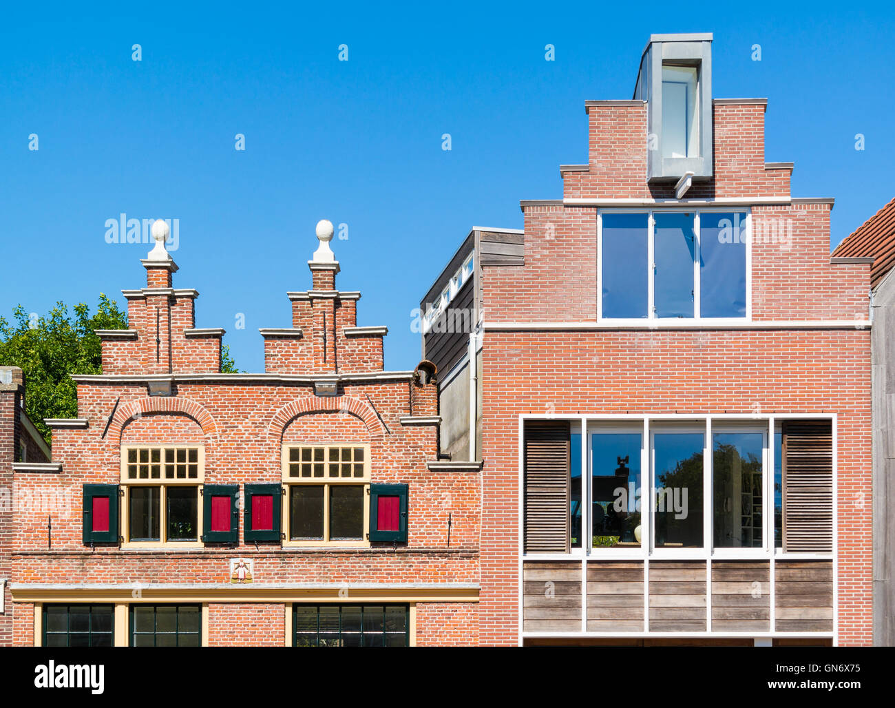 Top facades of stepped gables of old and modern brick house on ...