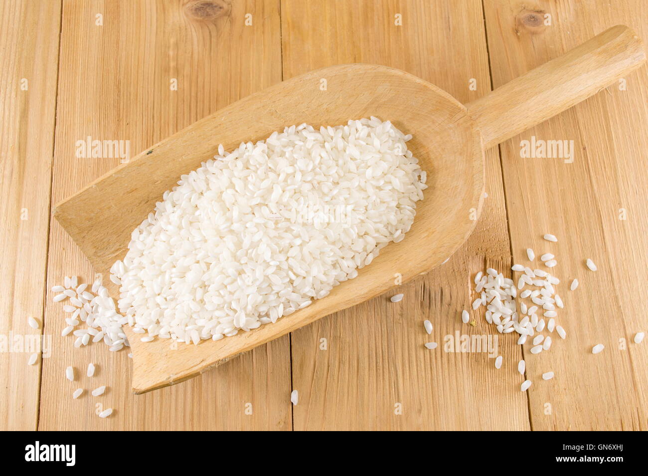 Rice in a big wooden spoon on the table Stock Photo - Alamy