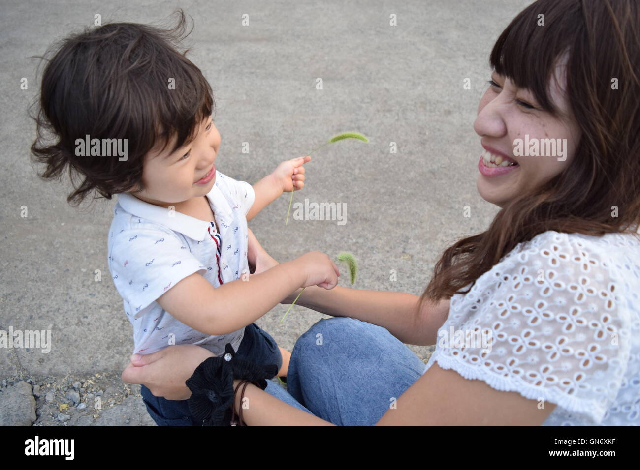 mother and her boy are palying outer place Stock Photo - Alamy