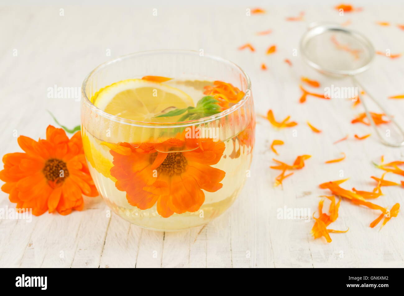 marigold flower herbal tea with lemon slices in a glass Stock Photo - Alamy