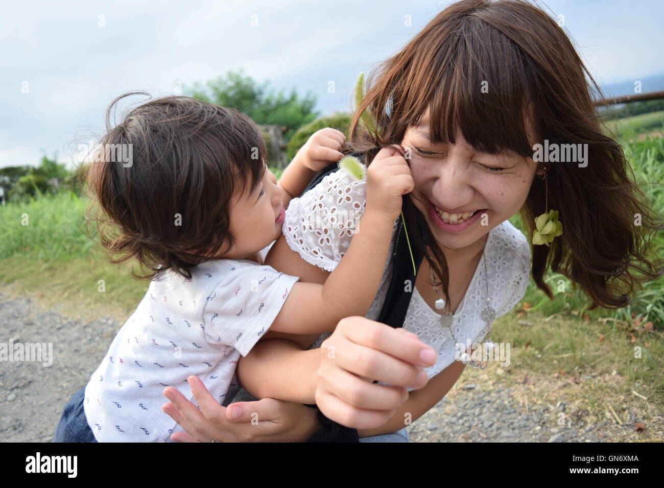 mother and her boy are palying outer place Stock Photo - Alamy