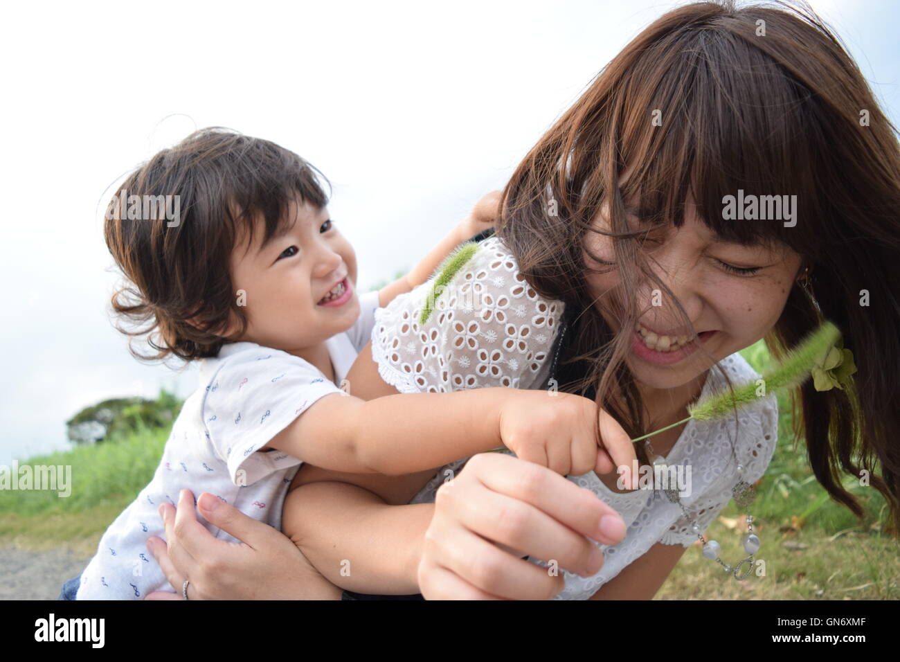 mother and her boy are palying outer place Stock Photo - Alamy