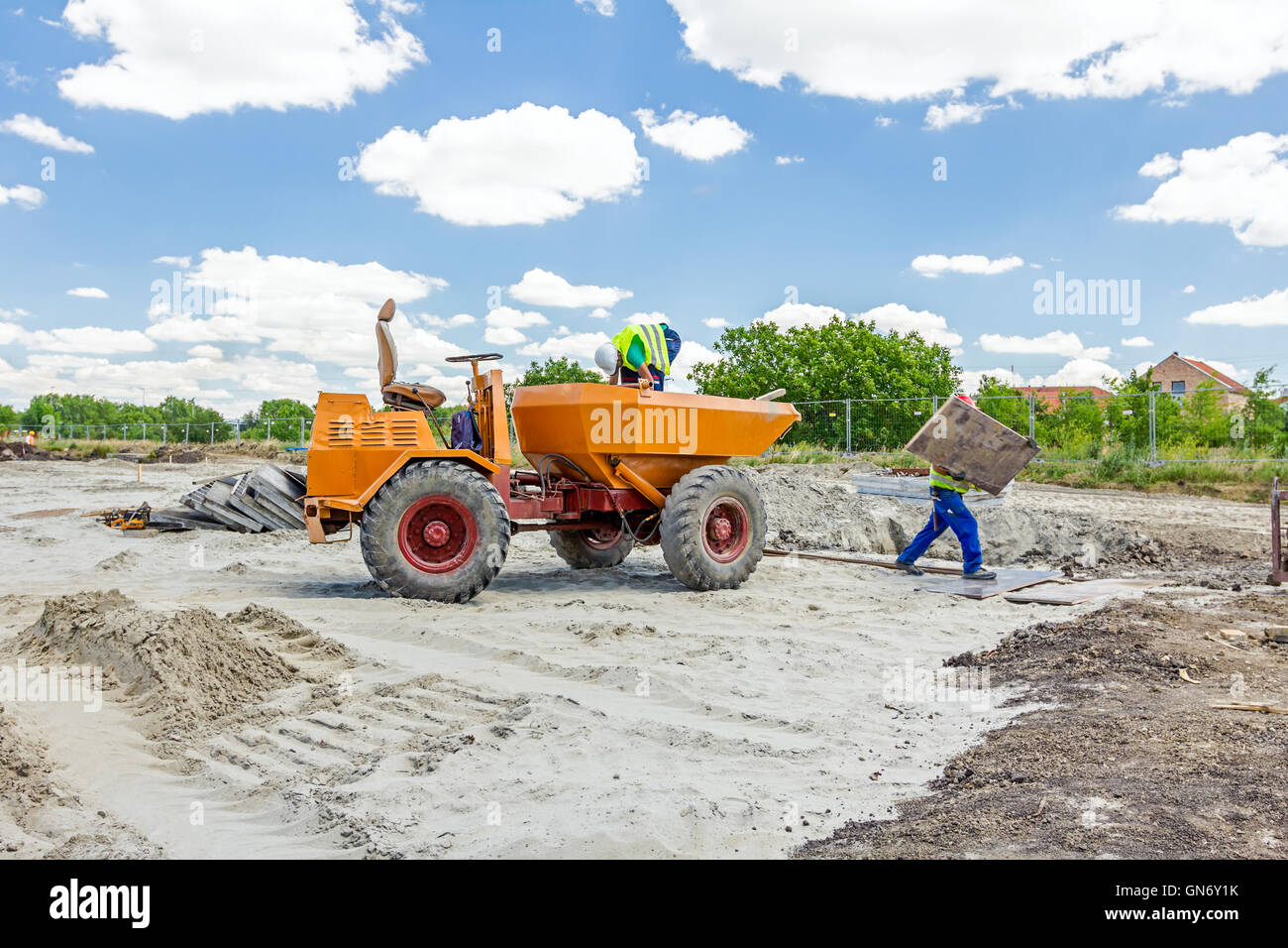 Little construction dumper carrier is at building site Stock Photo - Alamy