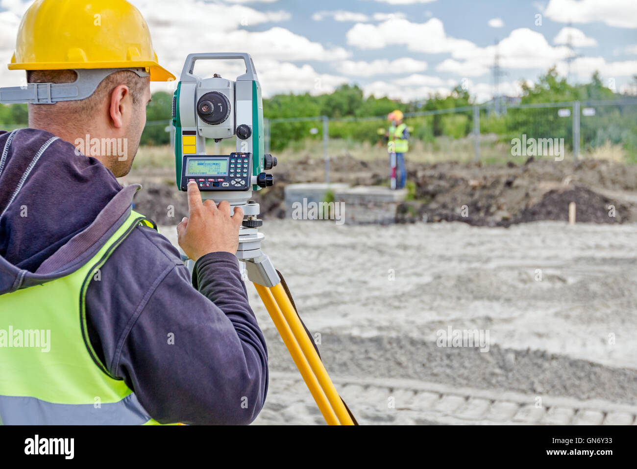 Surveyor engineer is measuring level on construction site. Surveyors ...