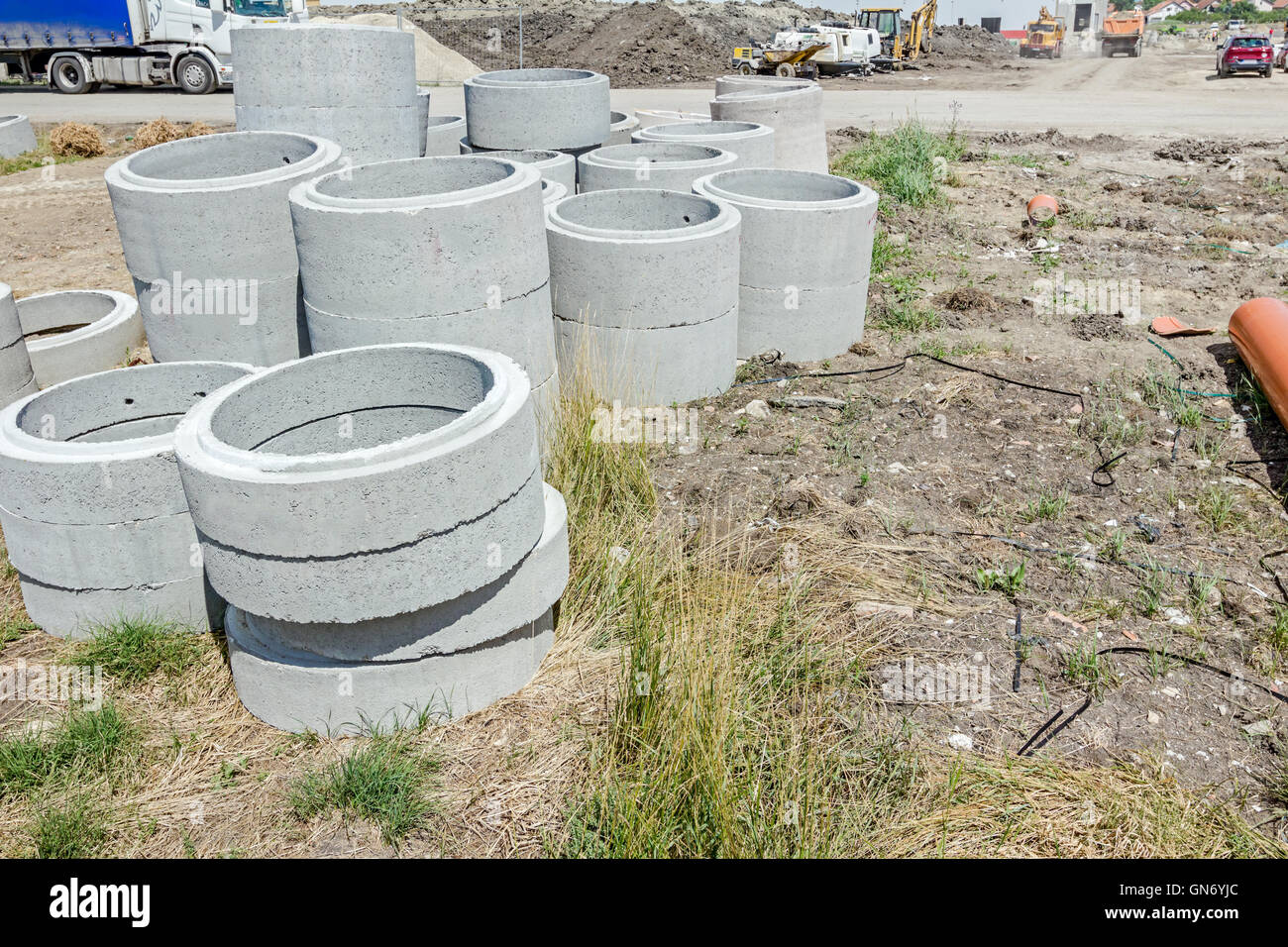 New concrete prefabricated pipes for manhole or drainage stacked at ...