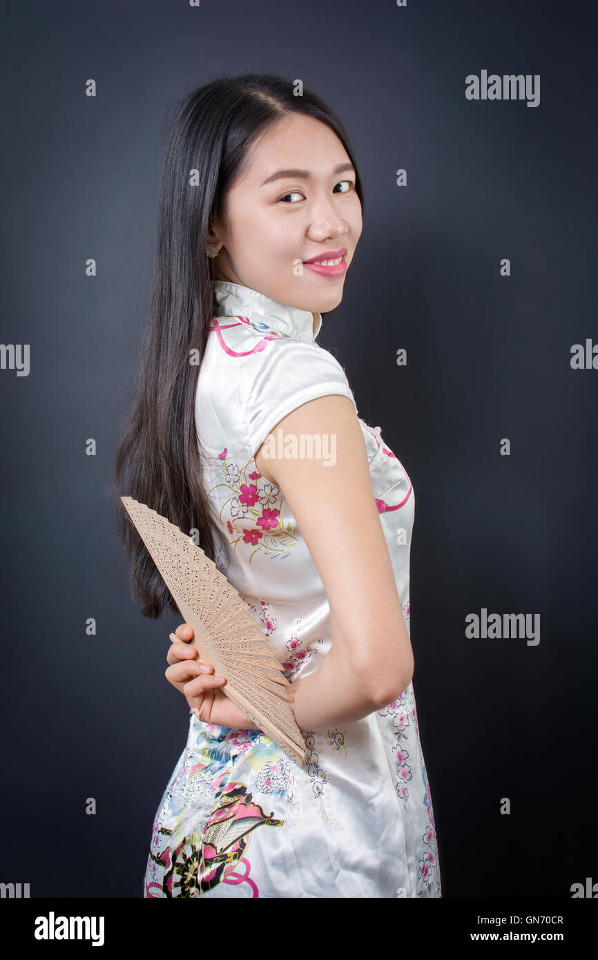 Beautiful Asian woman holding a hand fan Stock Photo - Alamy