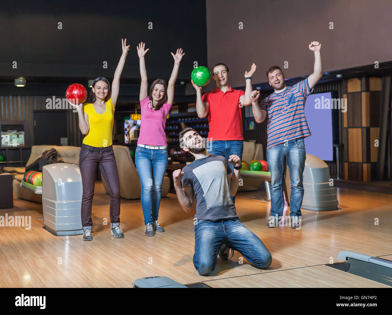 Happy team in bowling Stock Photo - Alamy