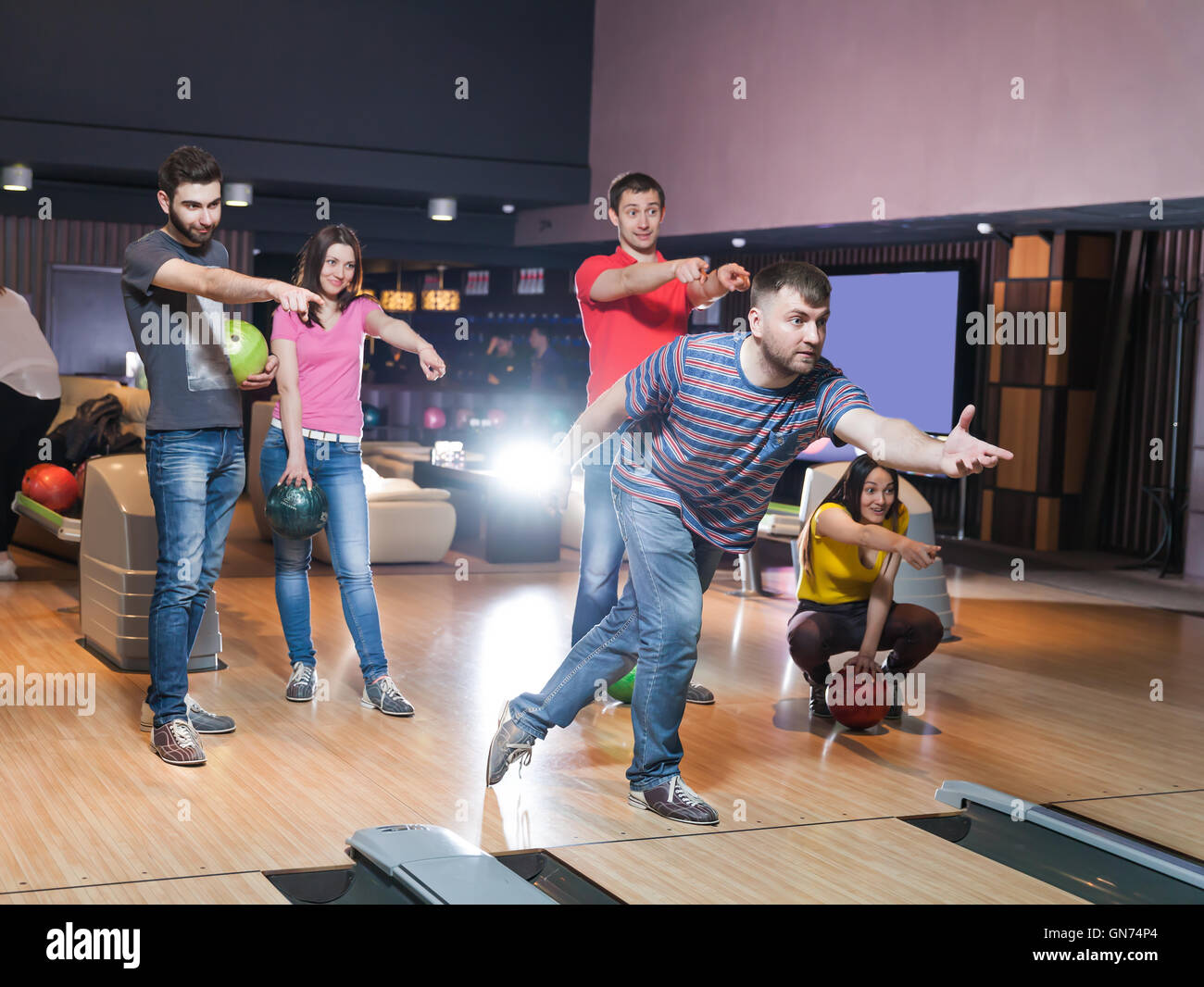 Friends having fun in bowling Stock Photo - Alamy
