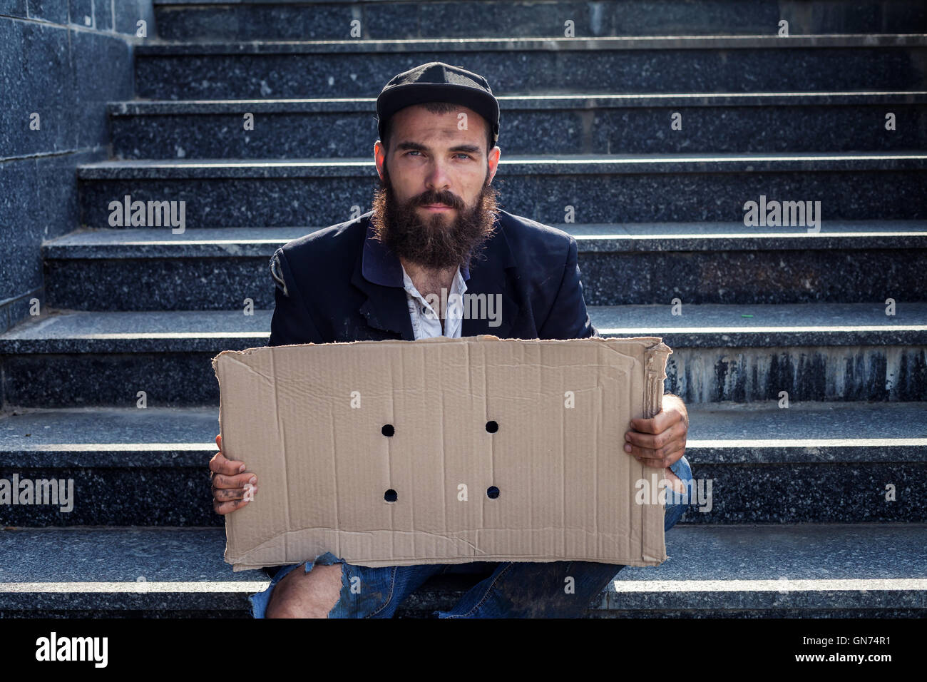 Vagrant with cardboard Stock Photo - Alamy