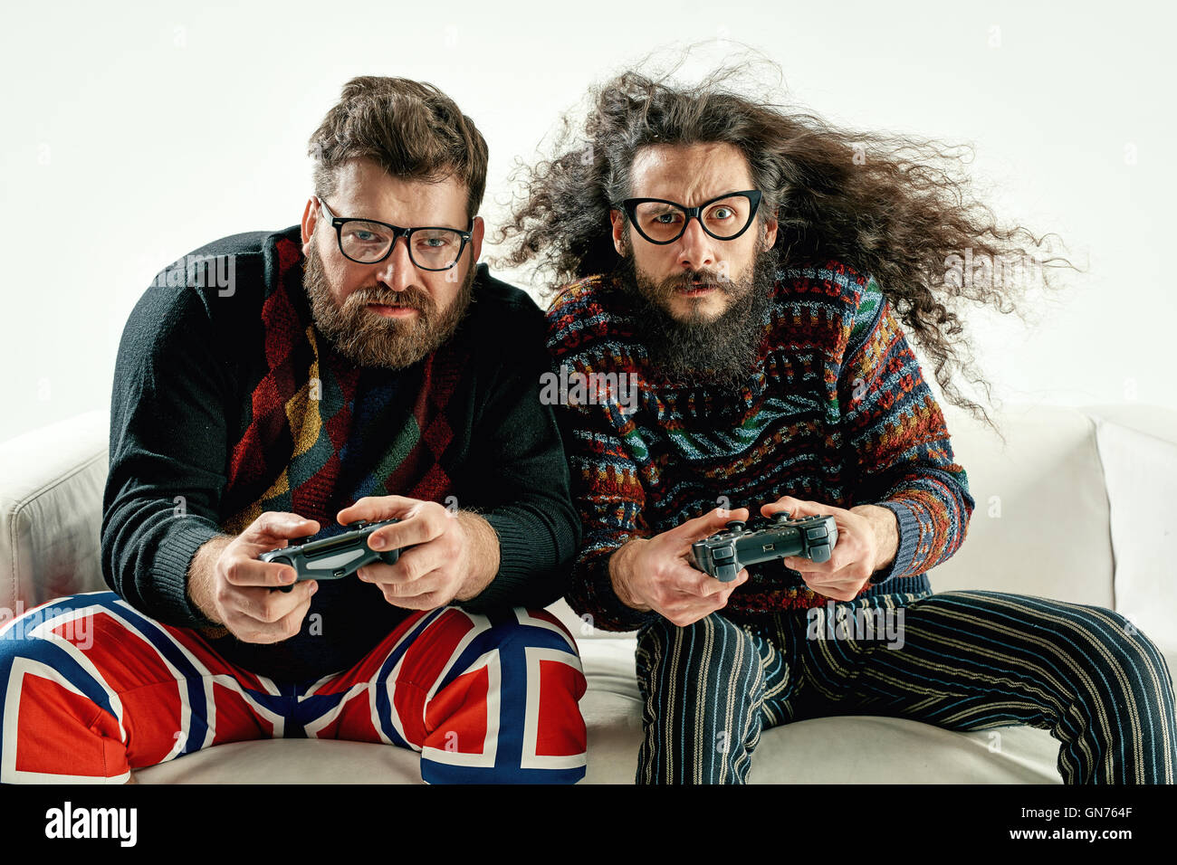 Funny portrait of two best friends playing console Stock Photo - Alamy