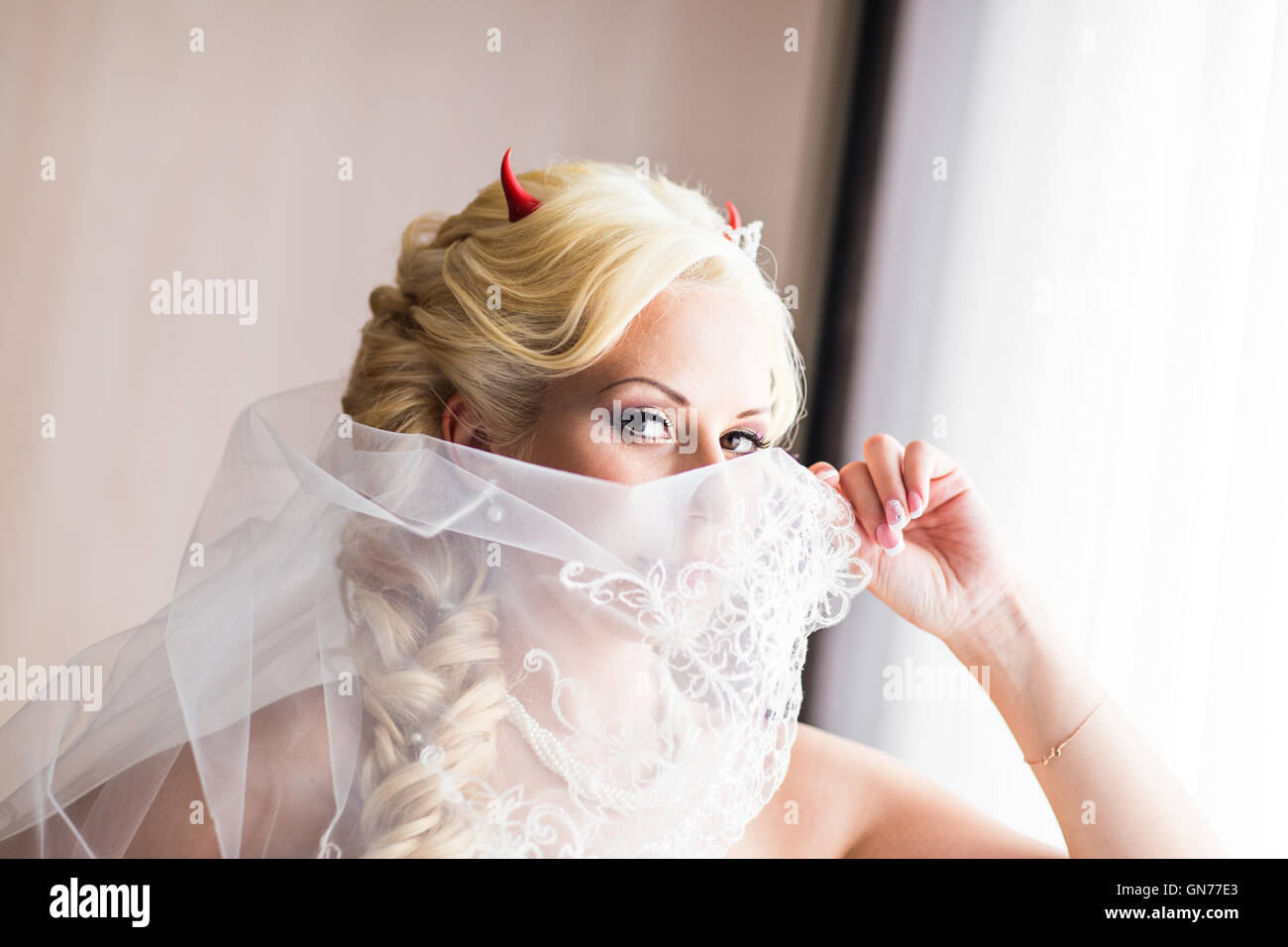 Bride with horns of the devil for Halloween Stock Photo - Alamy