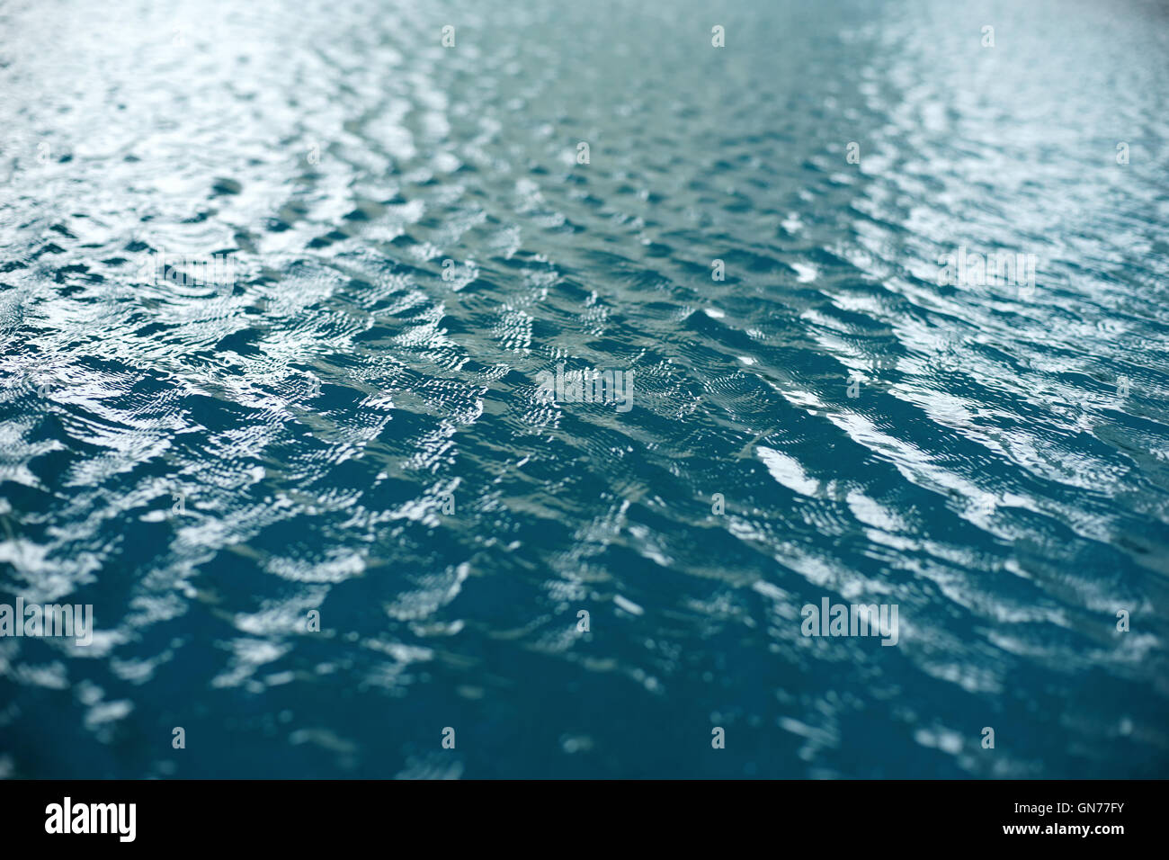 blue ripped water in swimming pool as background Stock Photo - Alamy