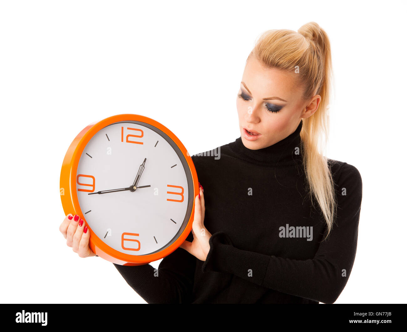 Worried woman with big orange clock gesturing delay, rush, nervous ...