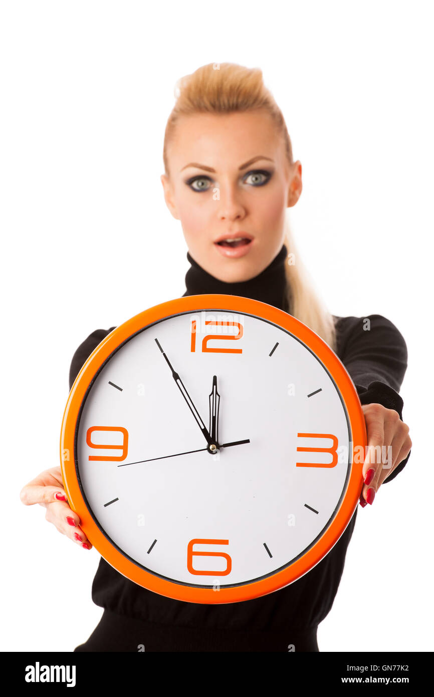 Worried woman with big orange clock gesturing delay, rush, nervous ...
