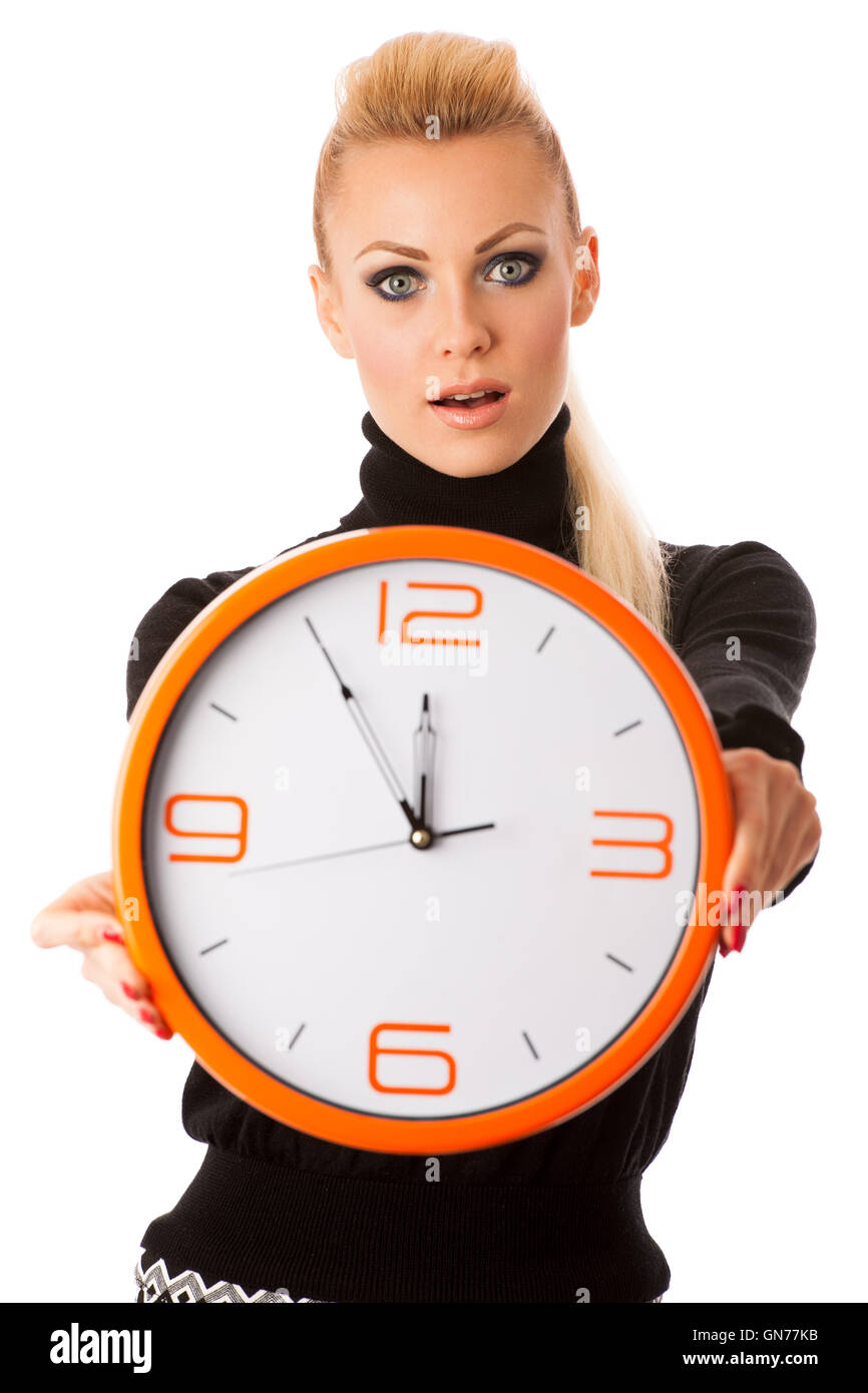 Worried woman with big orange clock gesturing delay, rush, nervous ...