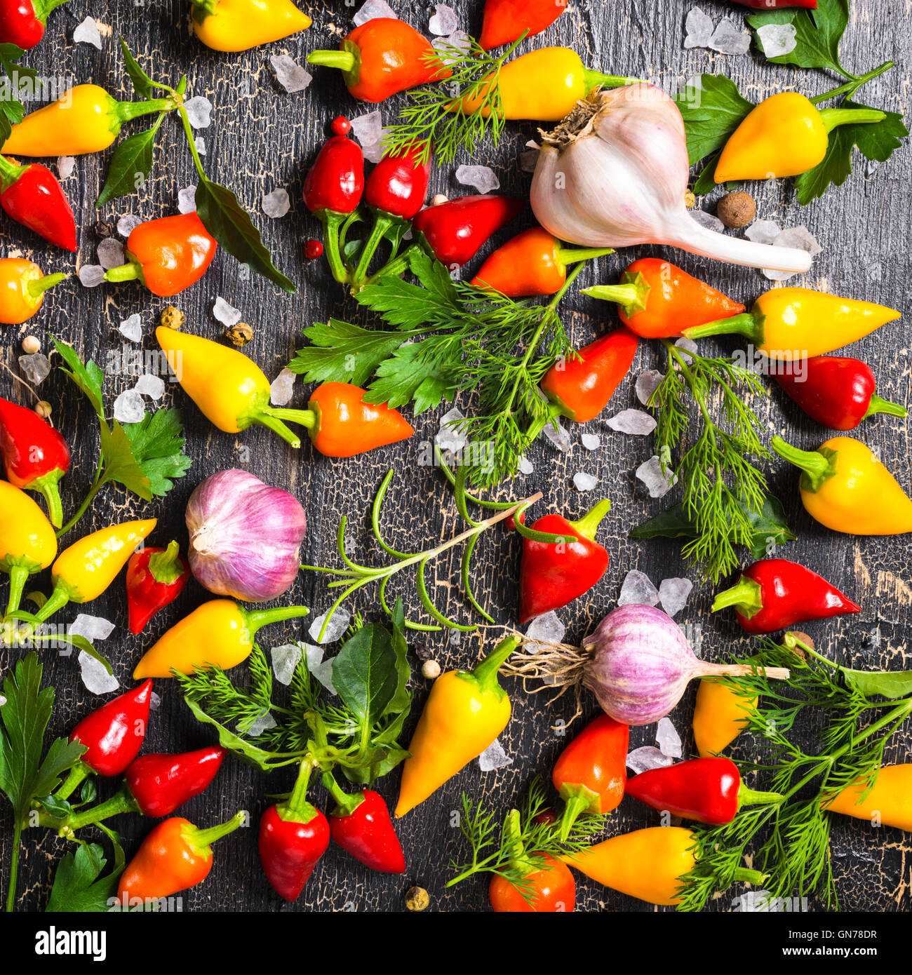 top view of ripe yellow, red hot chili peppers, sea salt, different ...