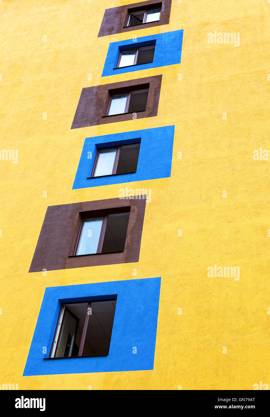 Windows on the facade of the yellow building Stock Photo - Alamy