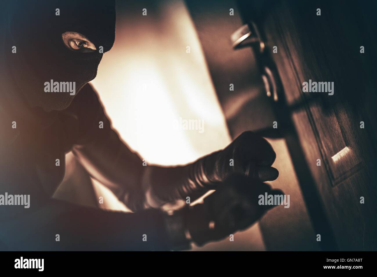 Caucasian House Burglar in Action. House Burglary Concept Photo. Home ...