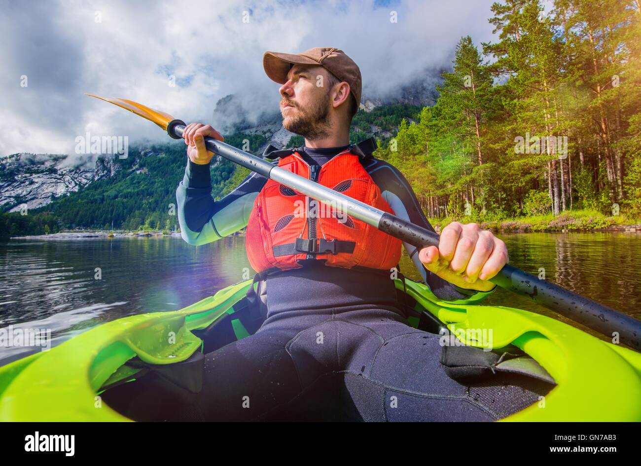 Kayak River Trip in Norway. Men in the Green Kayak Paddling and ...