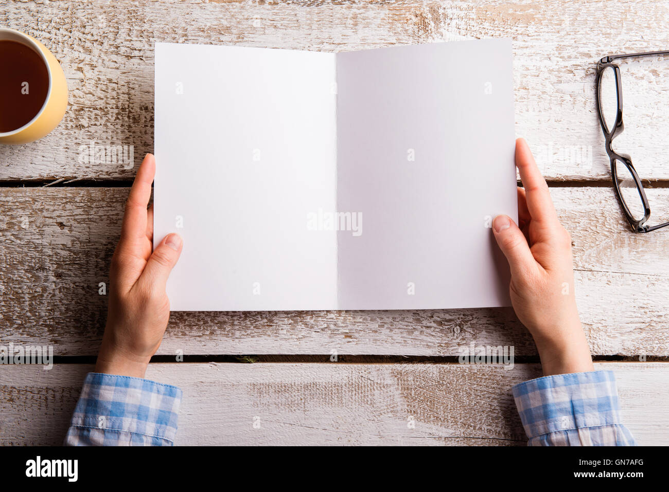 Unrecognizable woman holding empty greeting card. Studio shot Stock ...